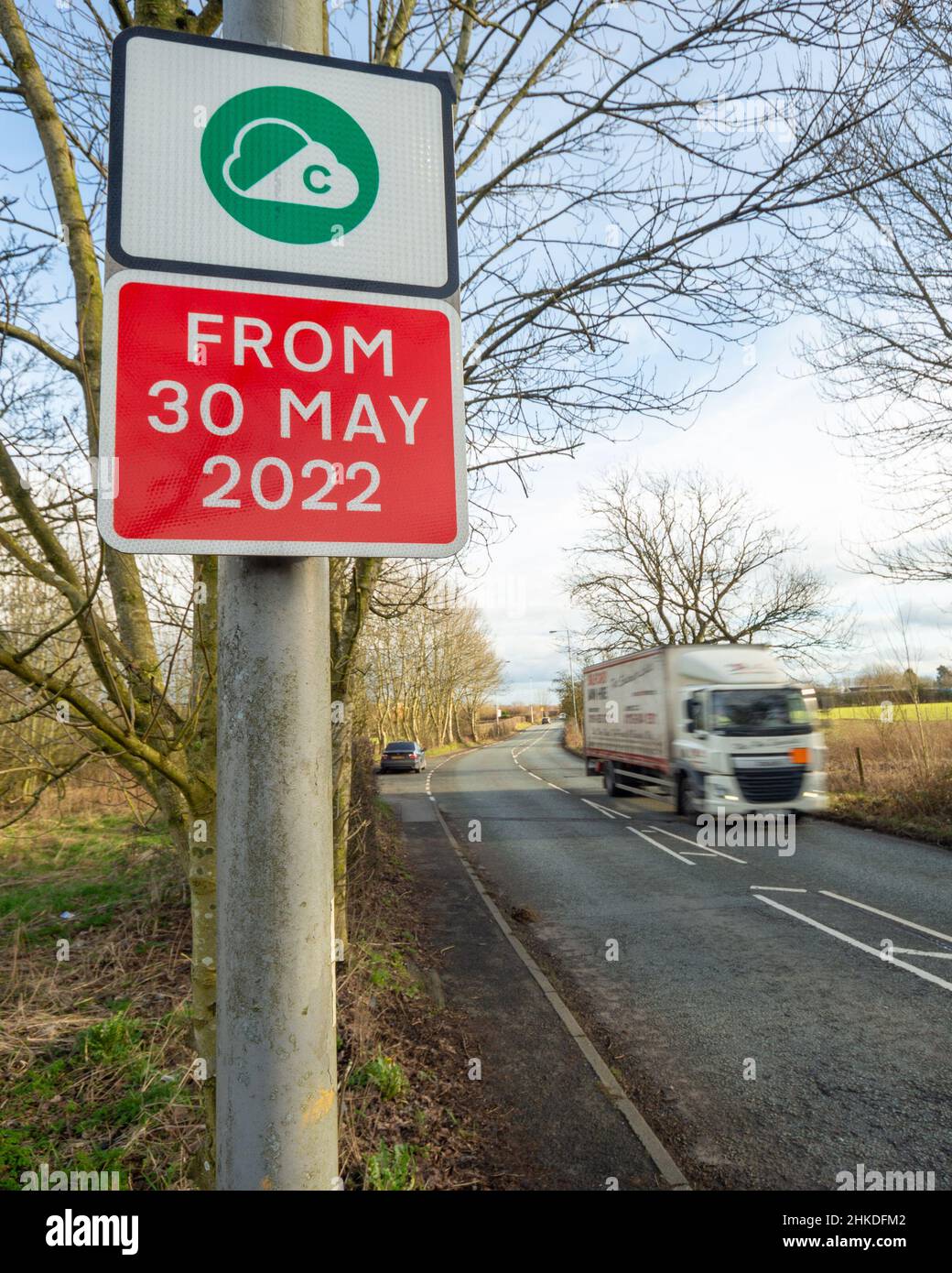 Greater Manchester Clean Air Zone sign next to a road as a truck drives ...