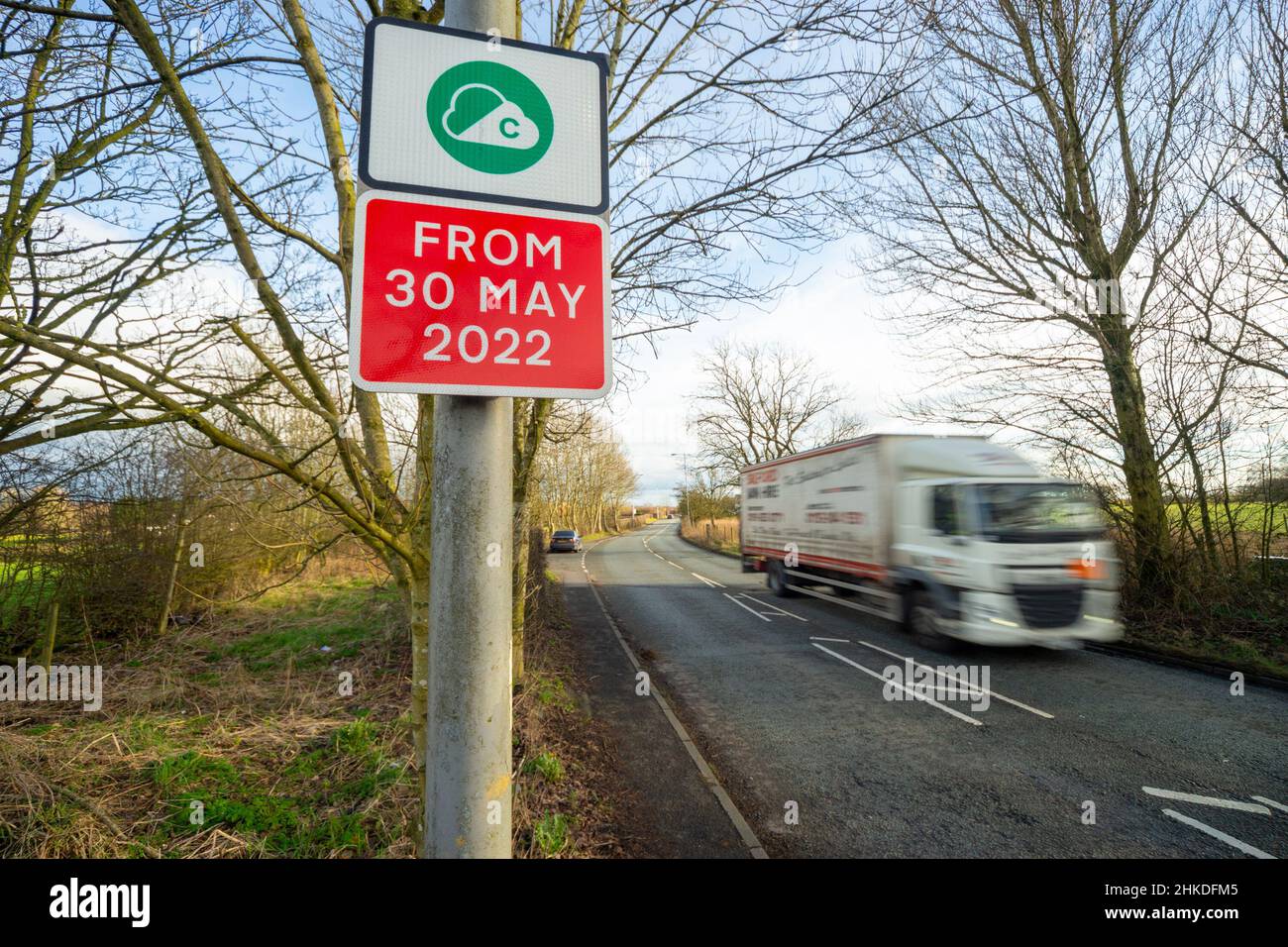 Greater Manchester Clean Air Zone sign next to a road as a truck drives ...