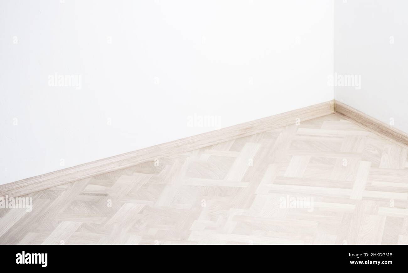 Room corner interior with white walls and floor with light wooden ...