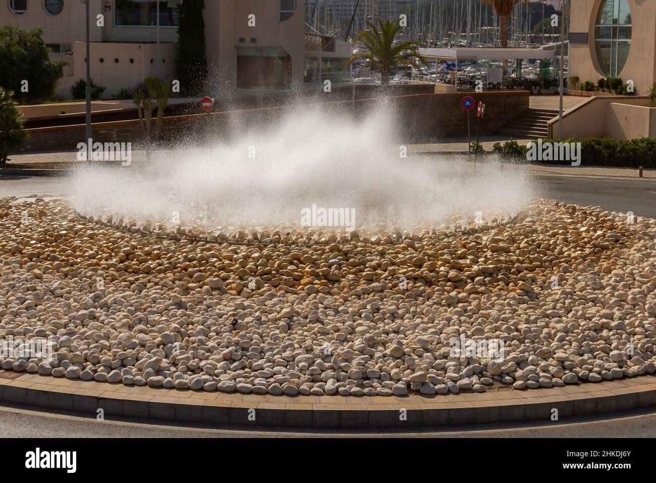 horizontal view of a fountain expelling water, built in a roundabout ...