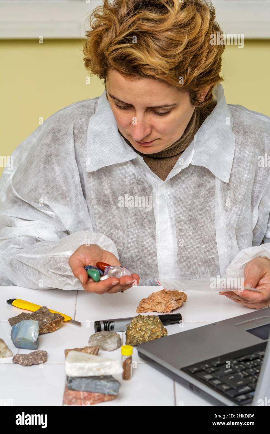 Female geologist researcher analysing rocks at her workplace Stock ...