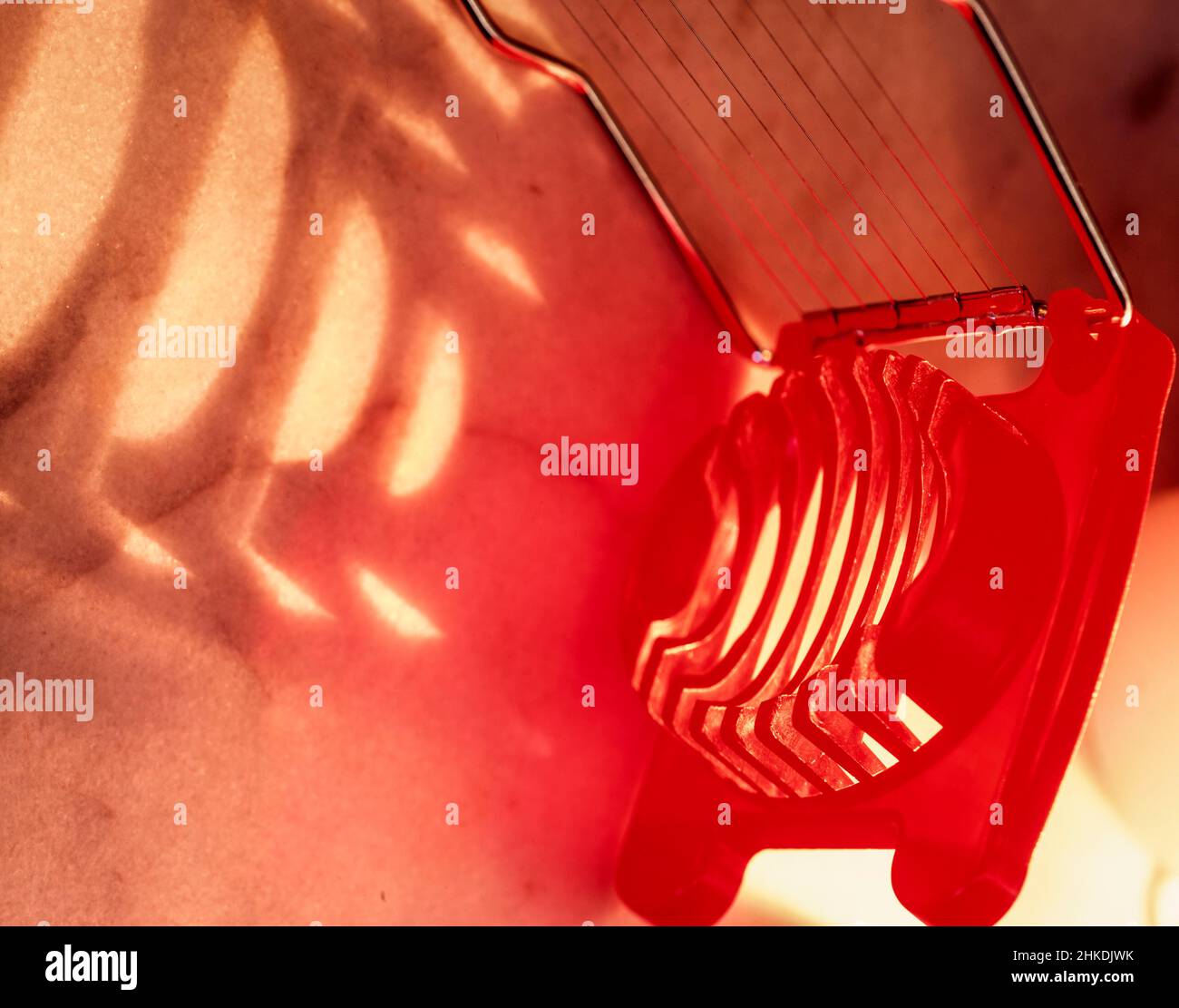 Print ready semi abstract still life of red Egg Slicer and receding ...