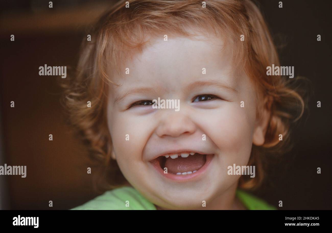 Portrait of a happy laughing child. Smiling infant, cute smile. Close ...