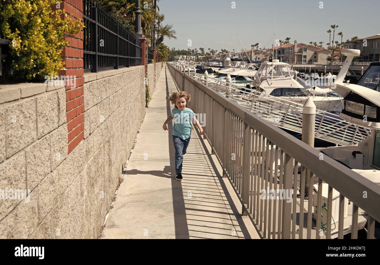 Summer activity. Active boy run on promenade. Activity holidays ...