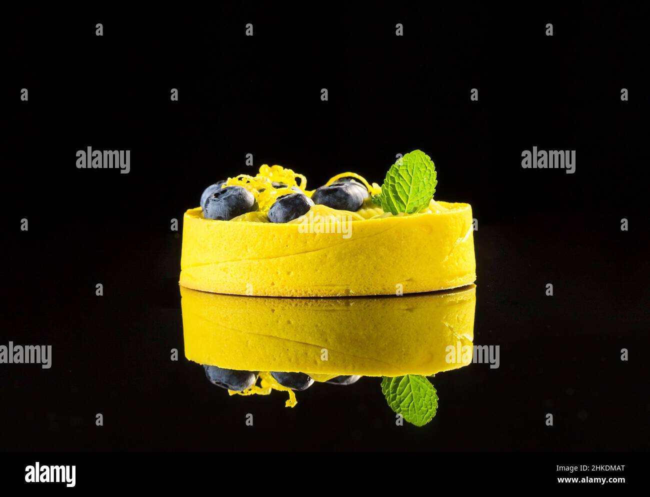 Yellow light dessert on a black background with reflection Stock Photo ...
