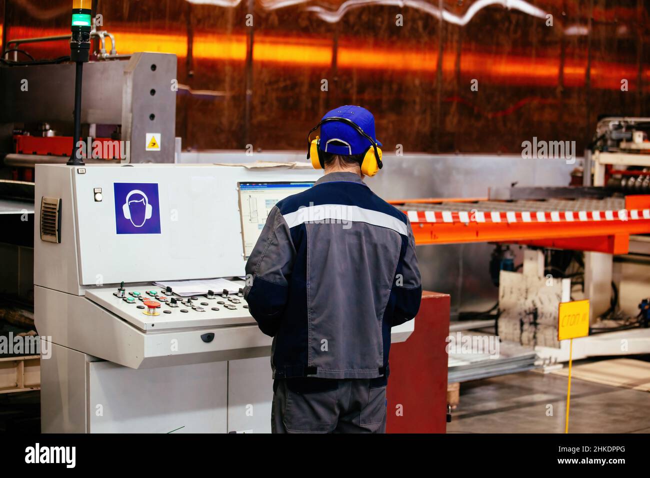 Factory worker operating CNC machine in metalworking workshop Stock ...