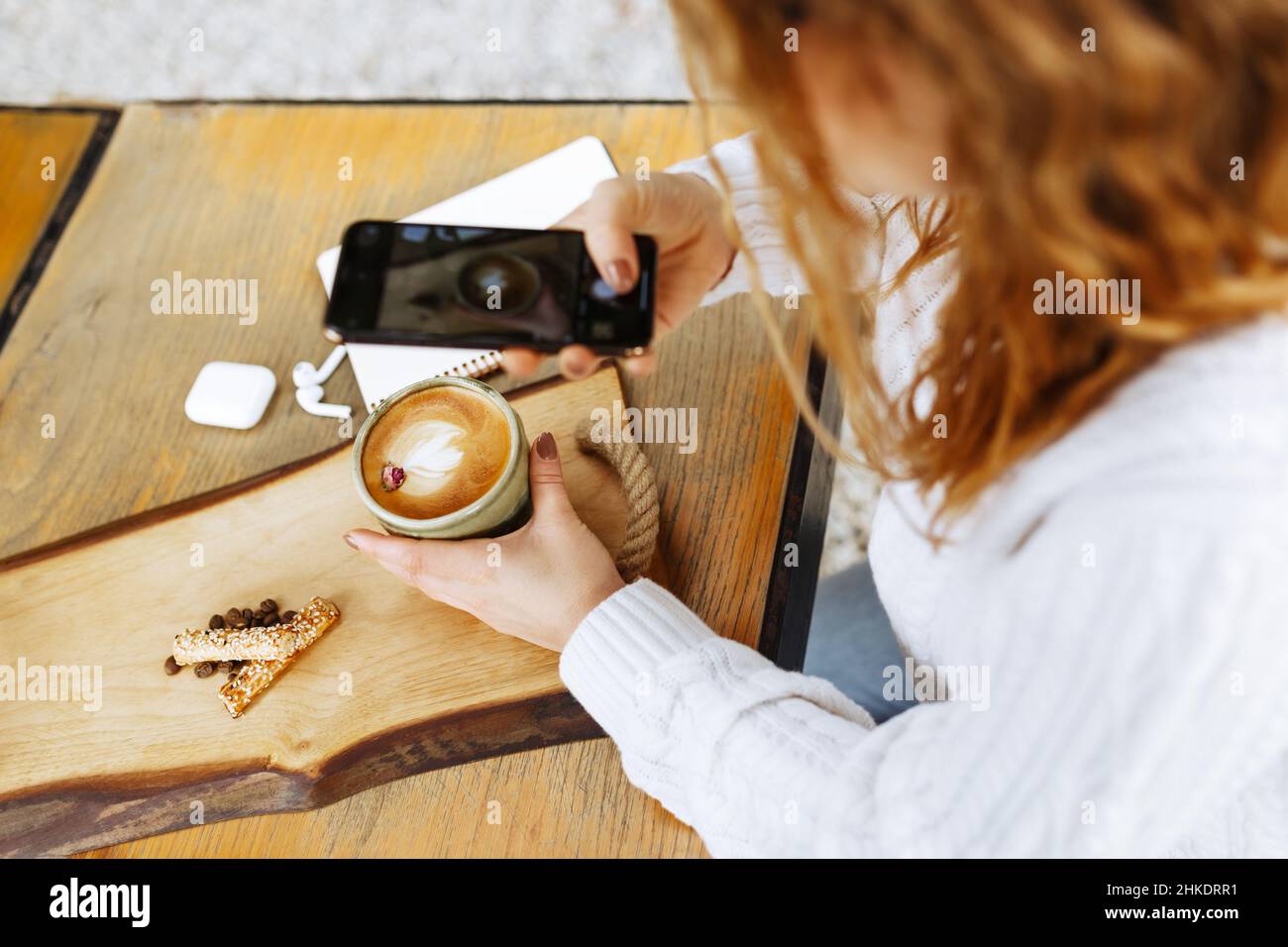 Woman hands taking a picture of a coffee cup with smart phone and ...