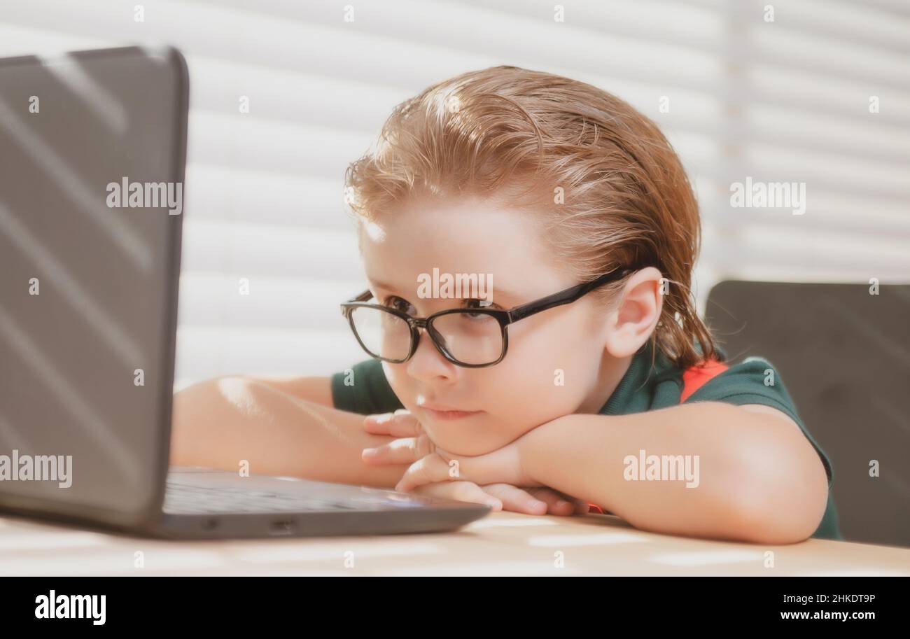 Schoolboy pupil studying at home using laptop. Home school, online ...