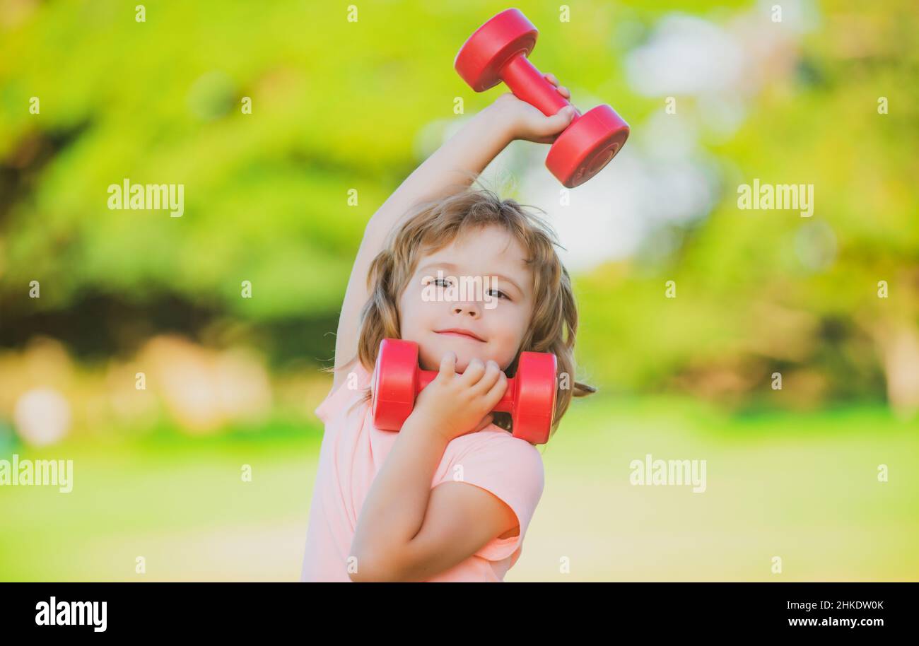 Boy workout in park. Kids sport. Child exercising with dumbbells ...