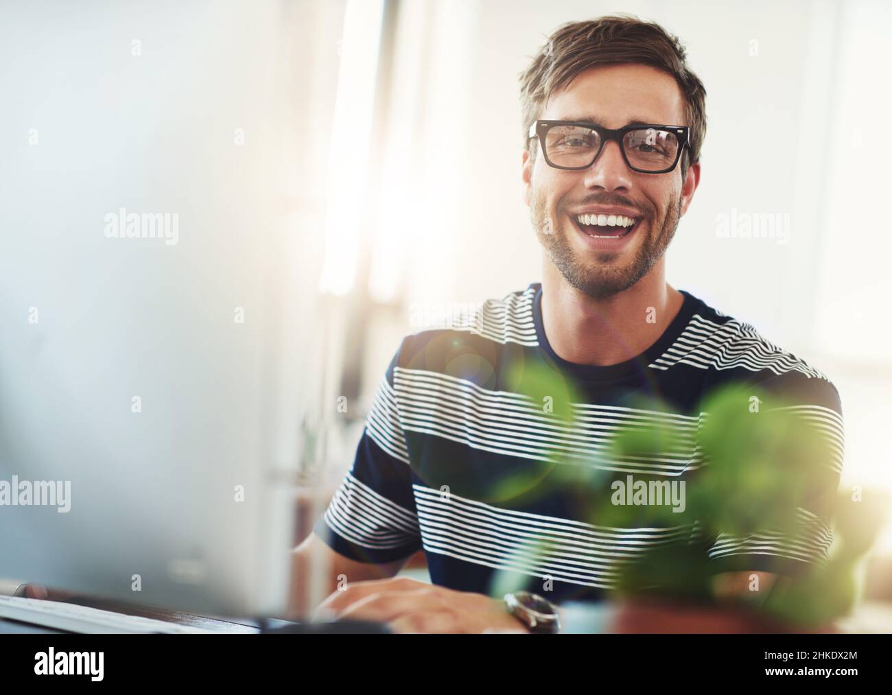 These designs won't create themselves. Portrait of a designer looking ...