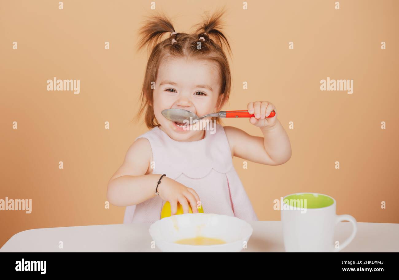 Kid eat healthy nutrition, baby food. Babies eating with spoon. Little ...