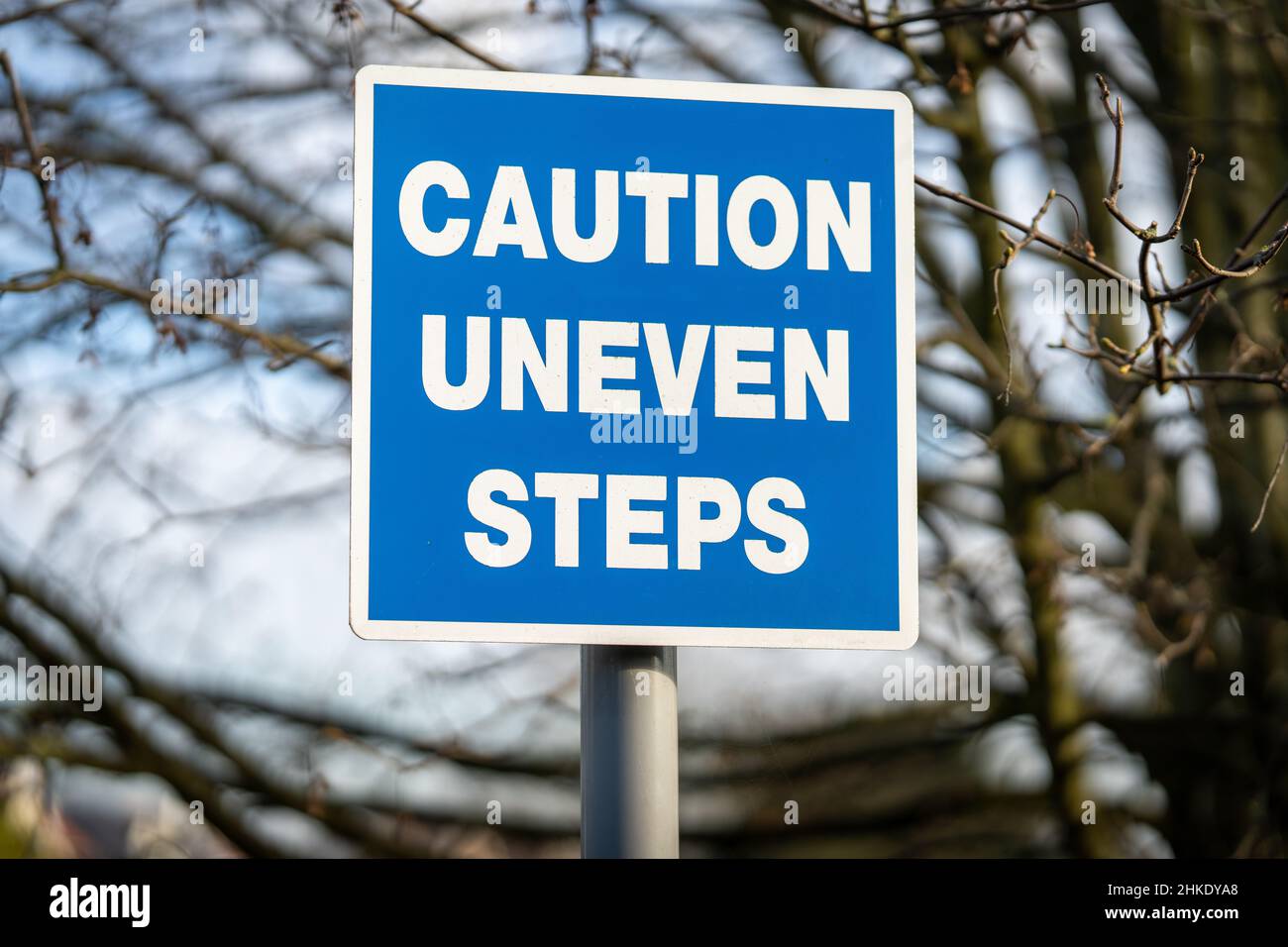 Closeup shot of a blue uneven steps sign Stock Photo - Alamy
