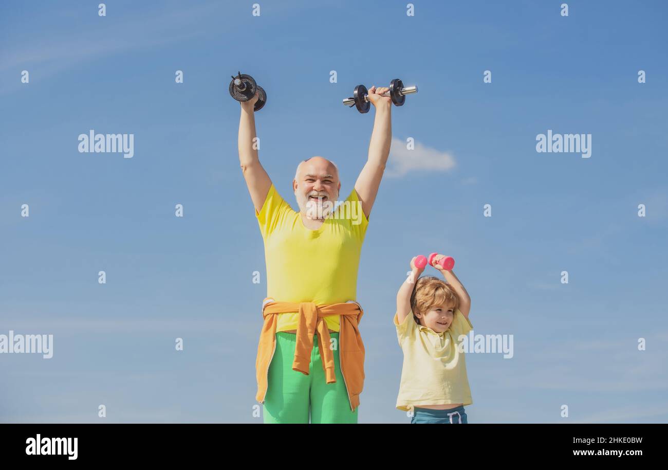 Sports education. Father and son build biceps and triceps. Sport and ...