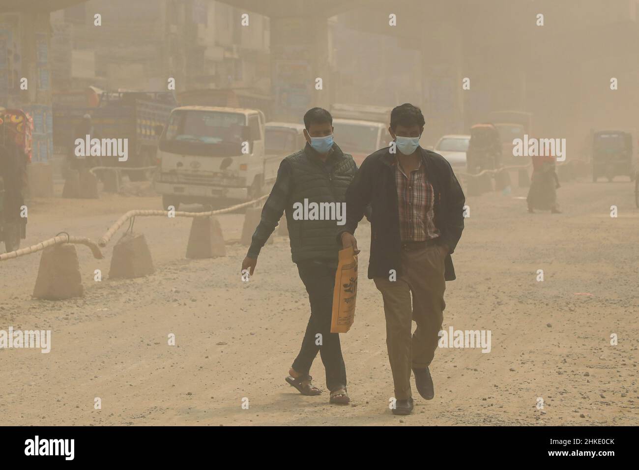 Dhaka, Bangladesh. 03rd Feb, 2022. Men seen crossing a dusty air ...