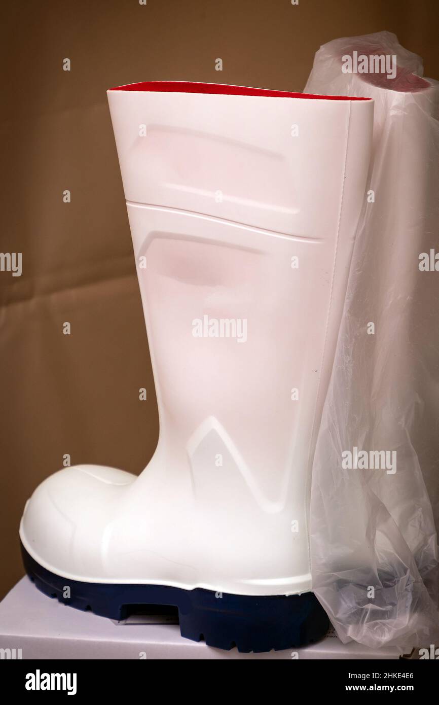 White rubber female rain boots inside house interior ready for wearing ...