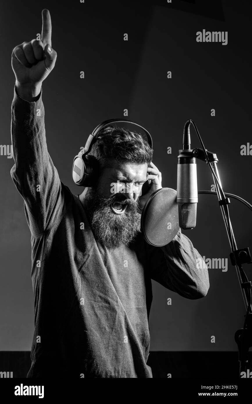 Handsome man in recording studio. Music performance vocal. Singer with ...