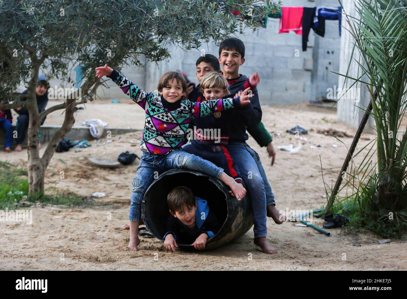 Palestinian children play in front of their house in a poor ...