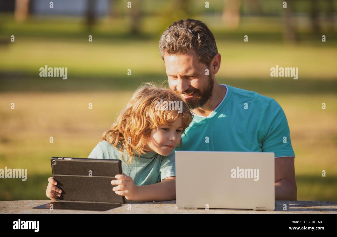 Father teaching son to use laptop, dad and school boy child looking ...