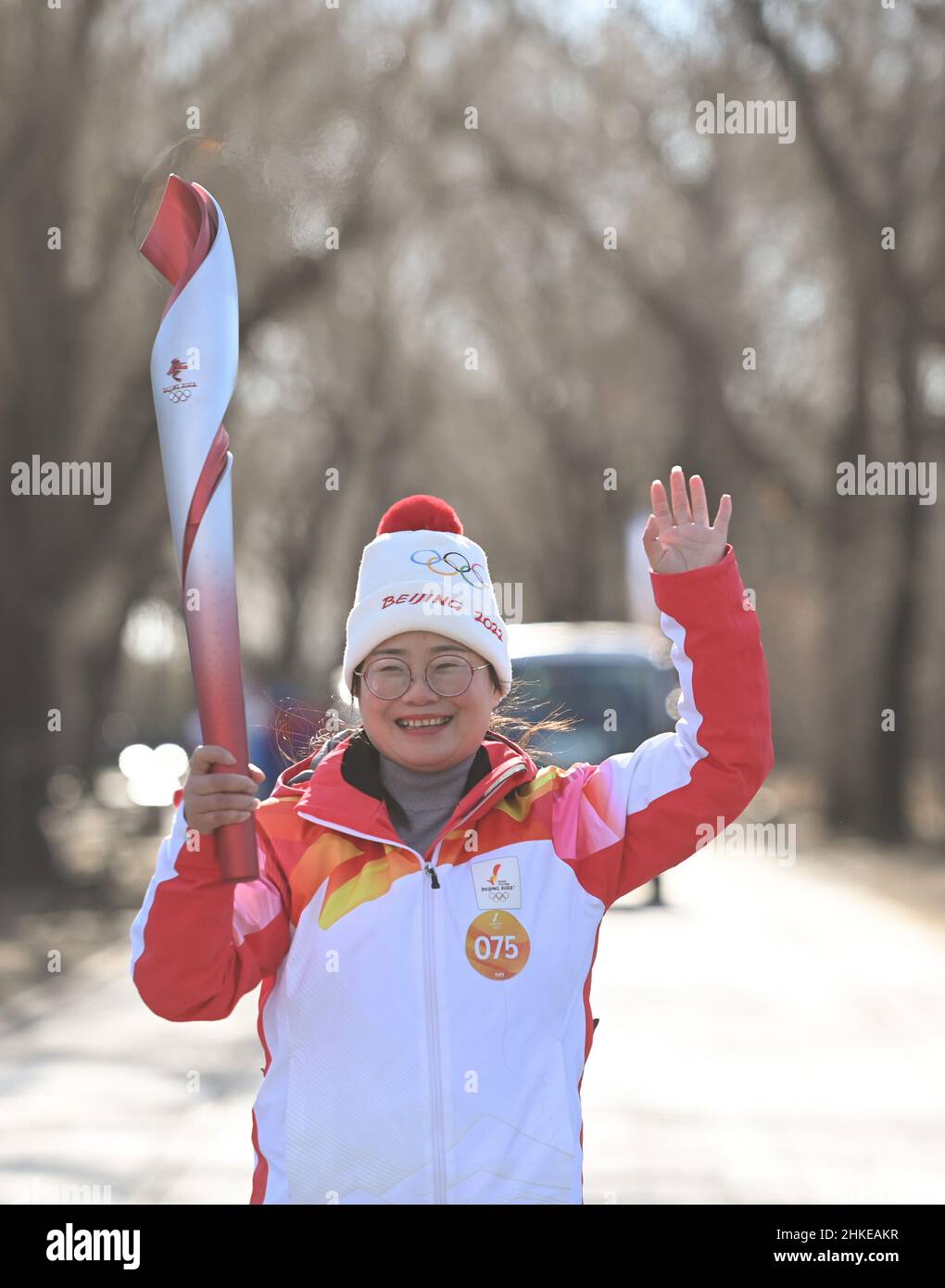 Beijing, China. 4th Feb, 2022. Torch bearer Hu Fang runs with the torch during the Beijing 2022 ...
