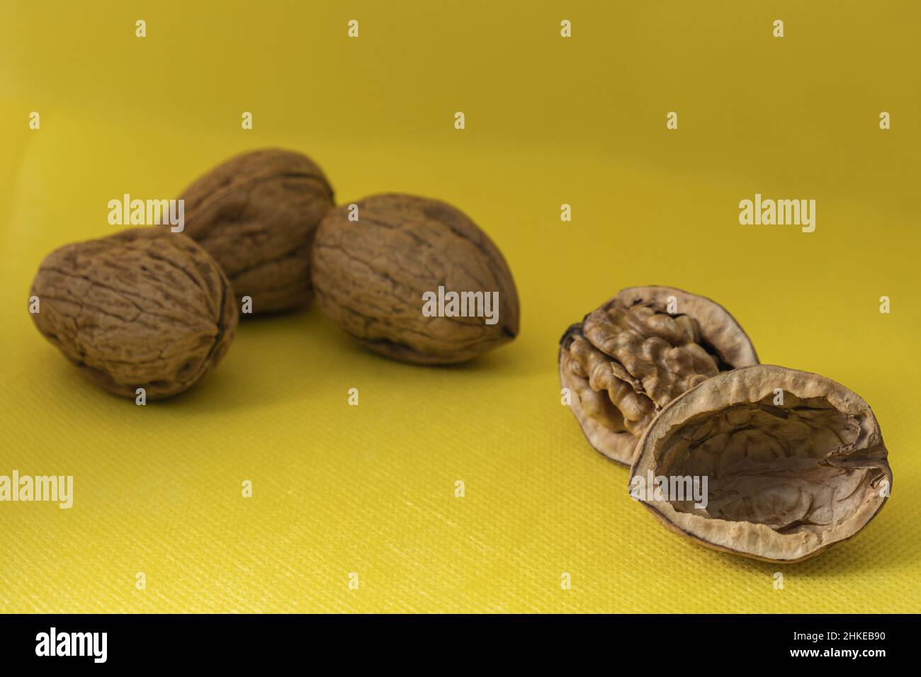 Closeup shot of walnuts isolated on yellow background Stock Photo - Alamy