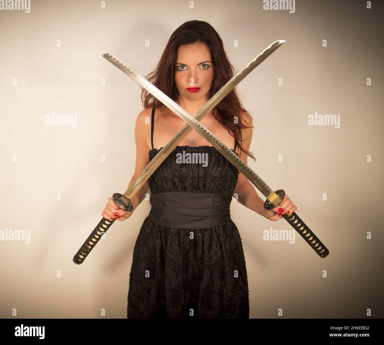 Beautiful Caucasian girl with a katana posing for a photo Stock Photo ...