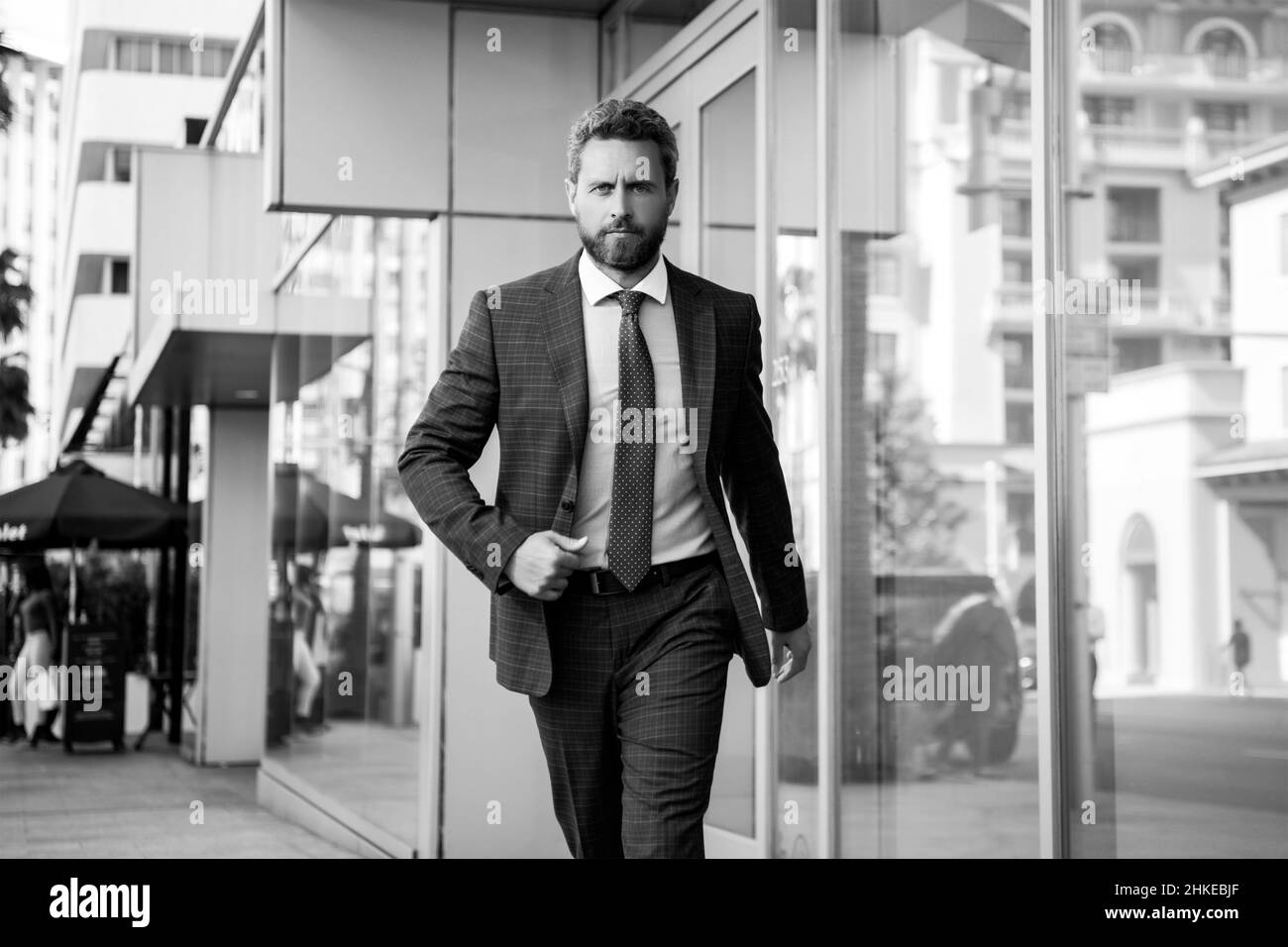 Businessman walking. Portrait of business man in front of modern office ...