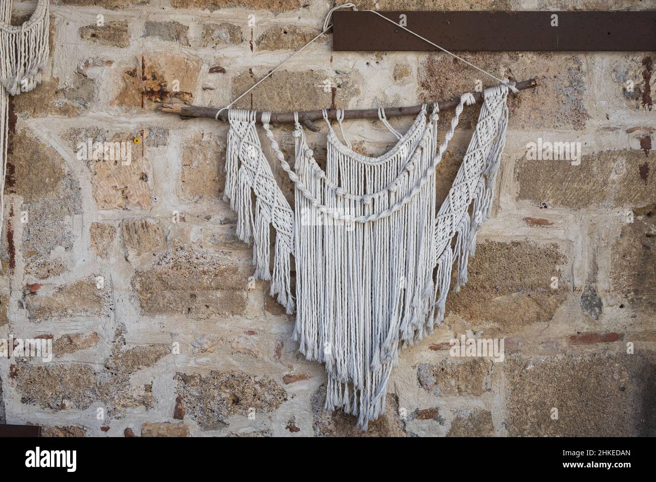 Wall mural in boho style made of cotton threads in natural color on a ...