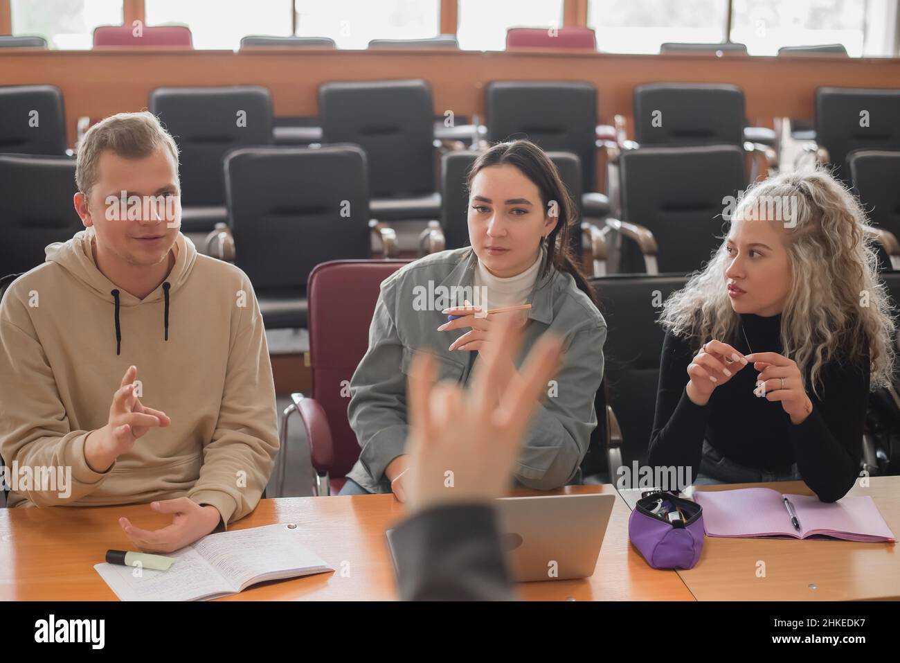The teacher and students communicate in sign language in the classroom ...