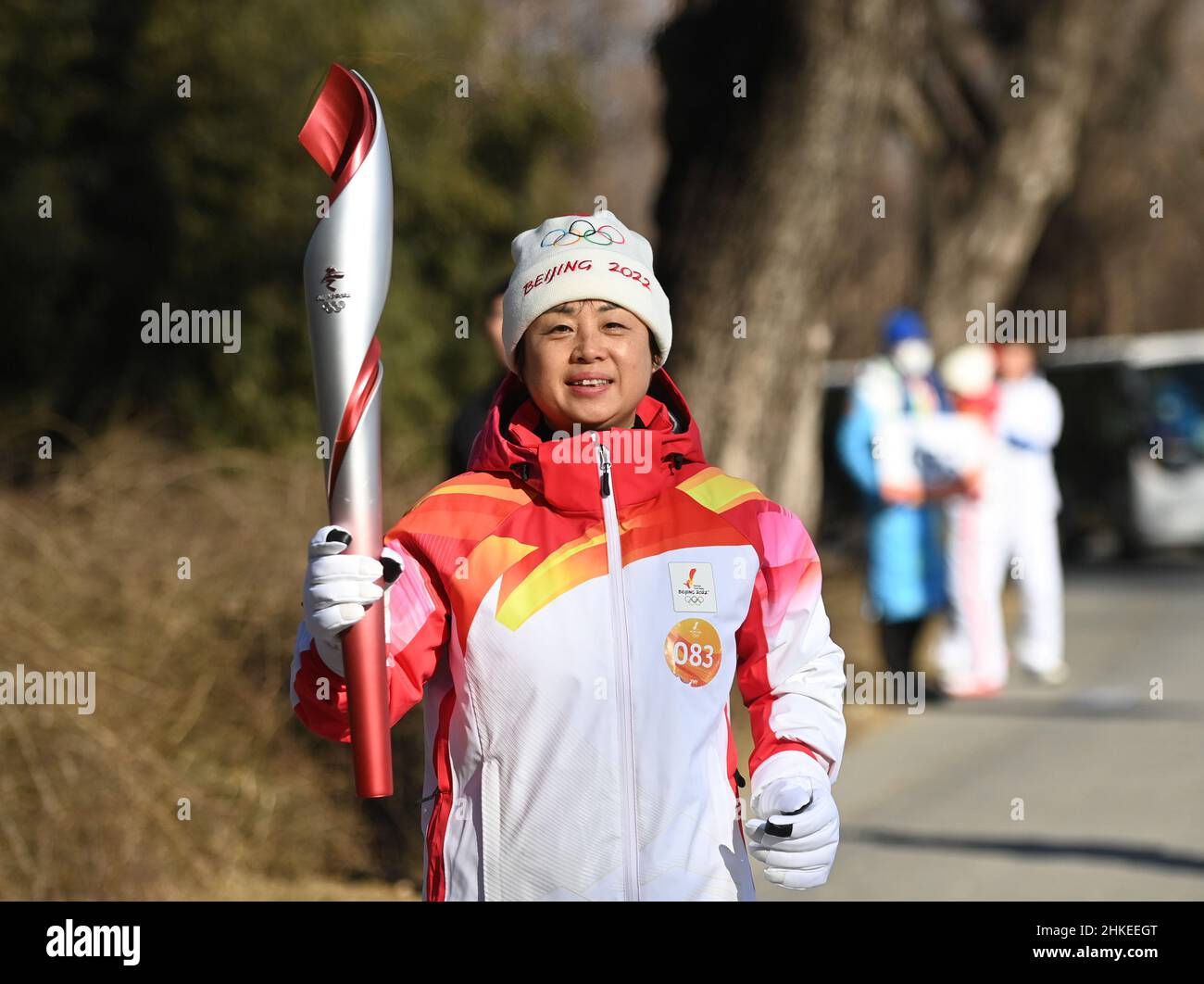 Beijing, China. 4th Feb, 2022. Torch bearer Tian Jihong runs with the ...