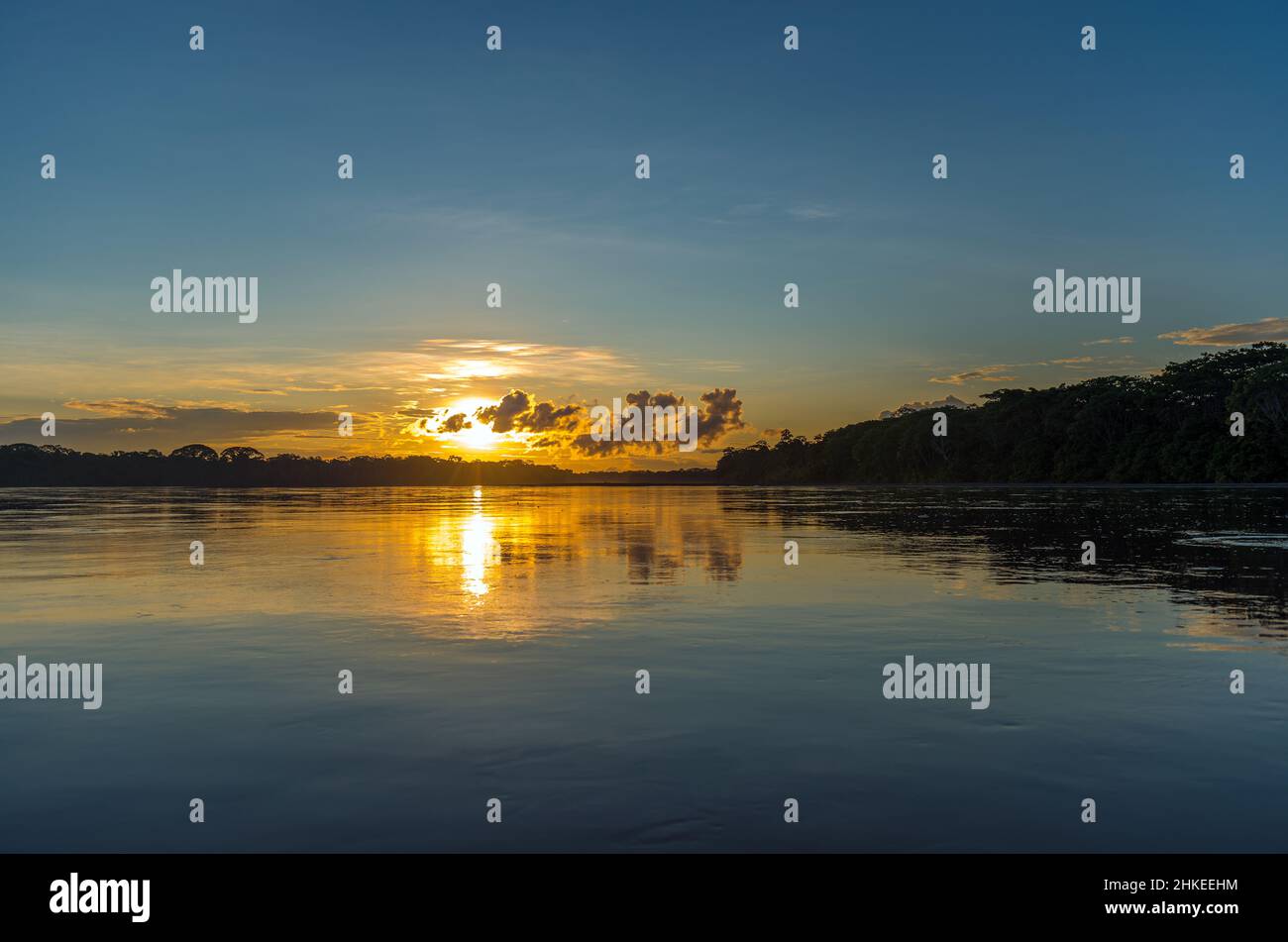 Sunset on the Amazon river during a boat trip with a reflection of the ...