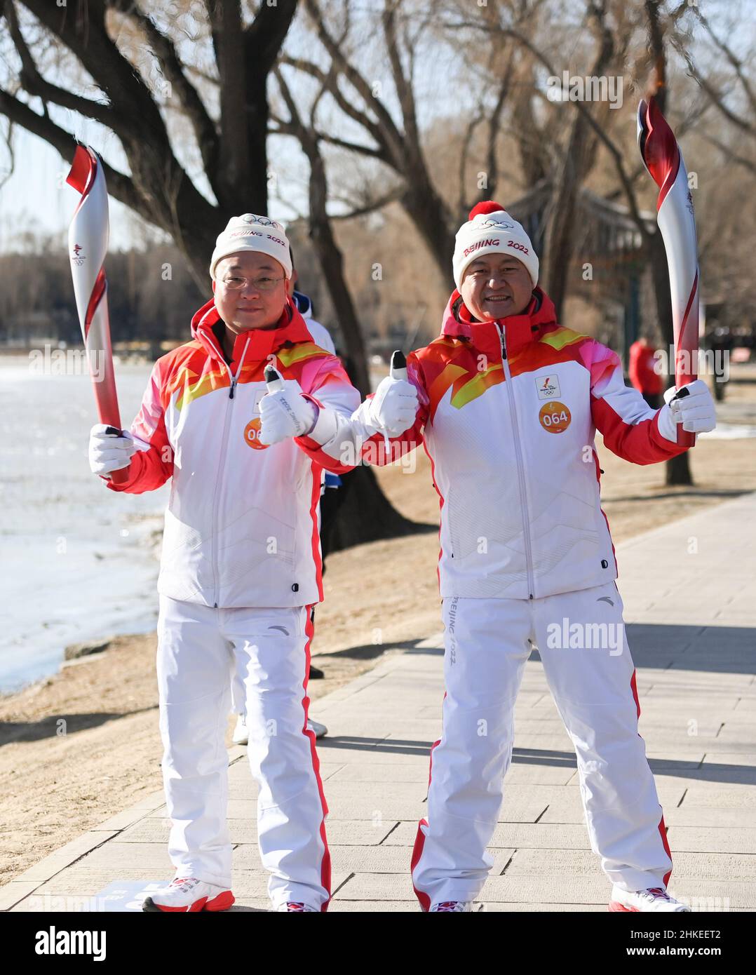 Beijing, China. 4th Feb, 2022. Torch bearer Zhou Guangtao (R) and Li ...