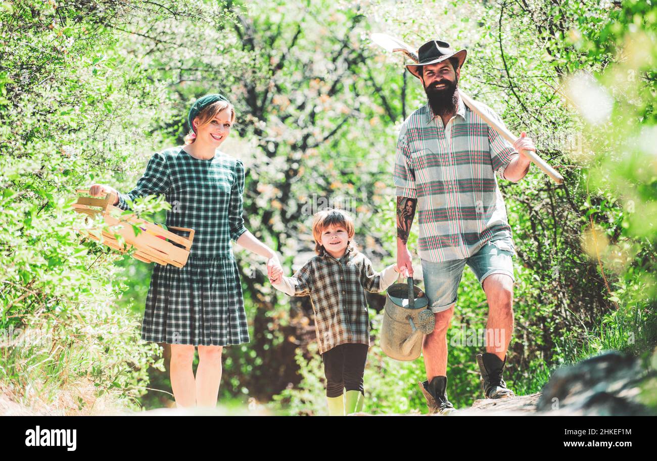 Family working together on farm. Country life. Family walking in ...