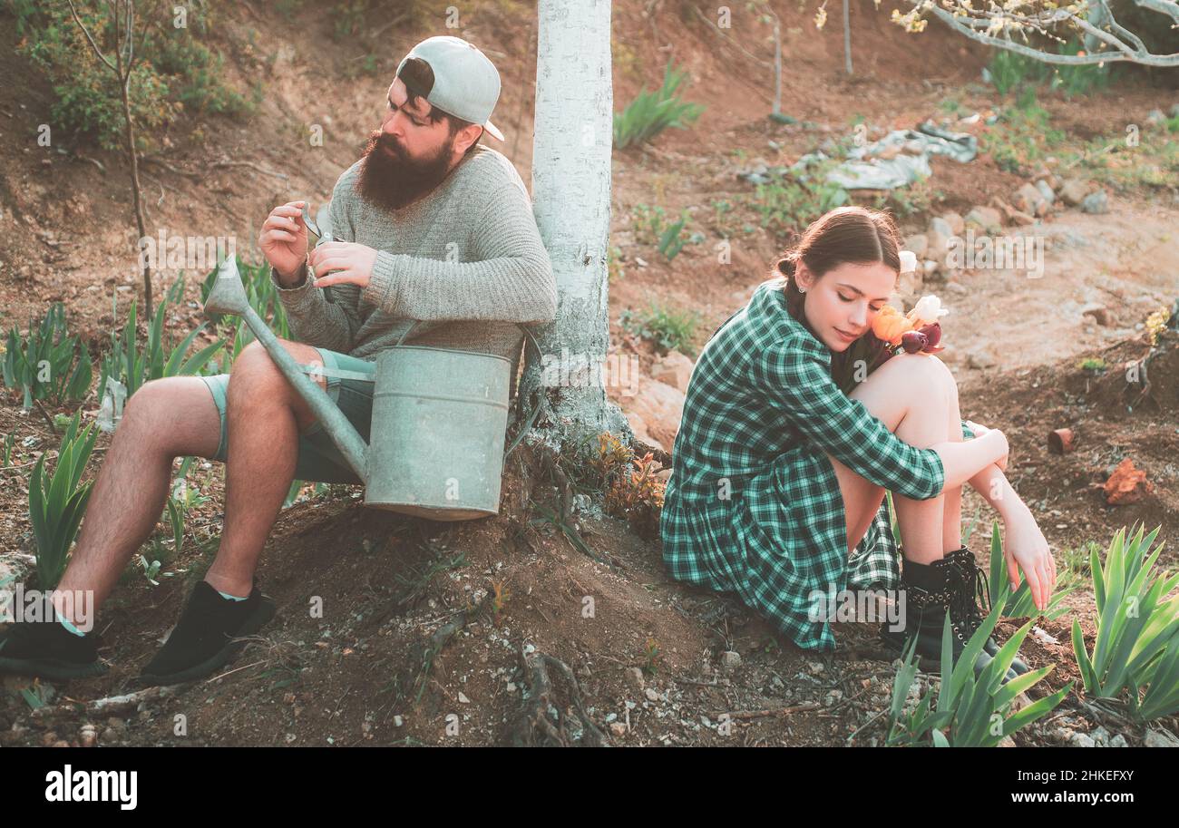 Couple Relax after hard work in spring Garden. Gardening agriculture ...