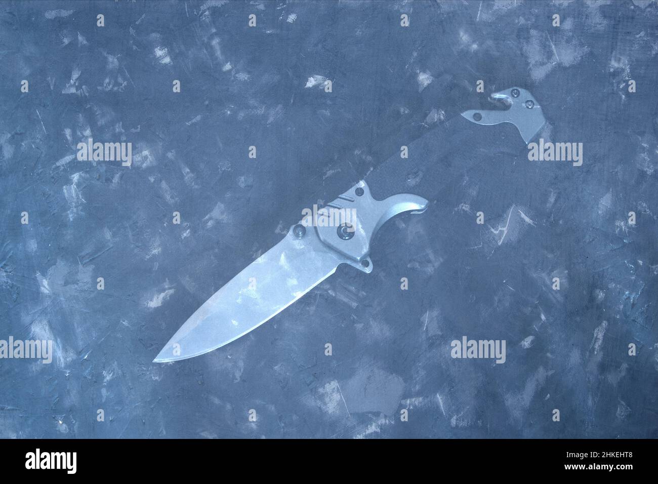 Frozen folding knife under ice, blurred out of focus Stock Photo - Alamy