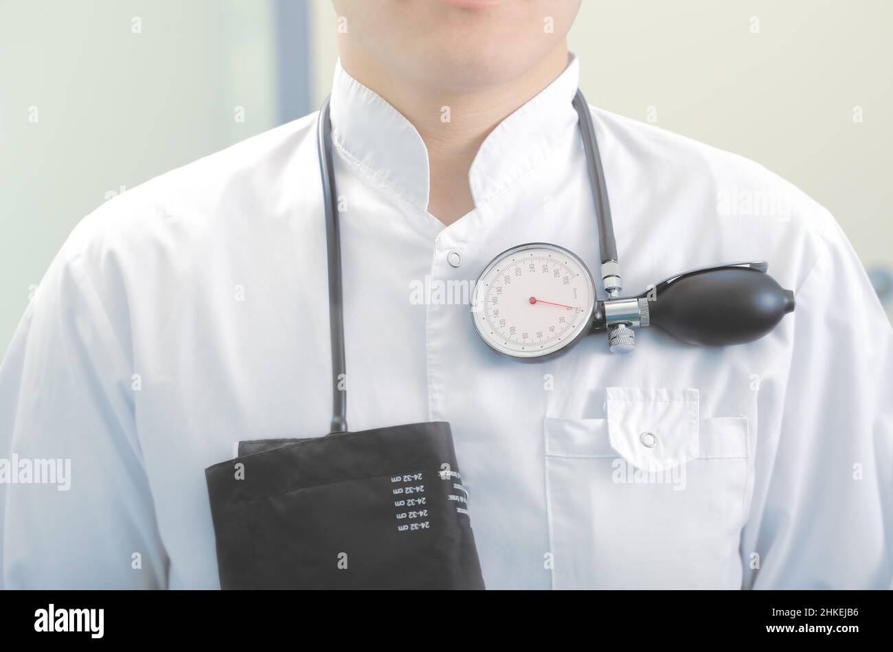 Male doctor in the white coat with BP cuff in the neck ready to work ...