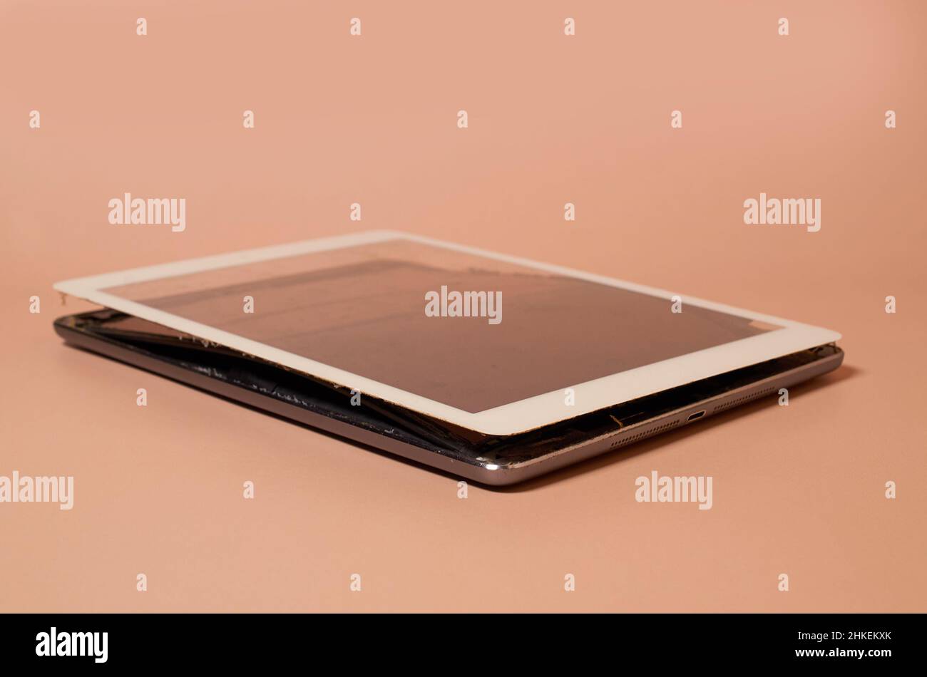 A broken tablet with a swollen battery and a dirty screen Stock Photo ...