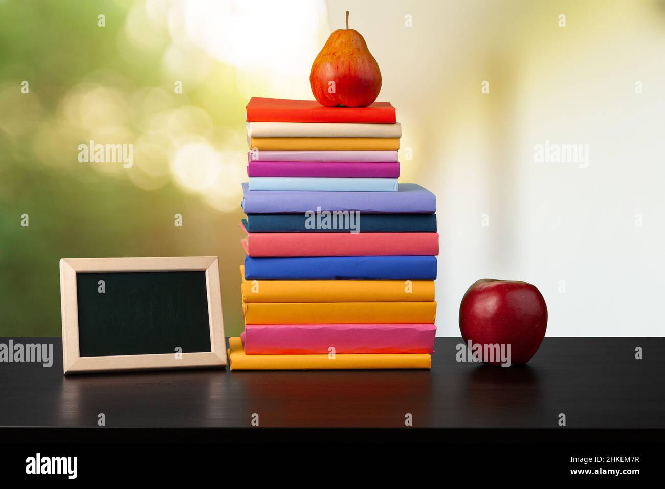 Stack of books on wooden table against blurred background Stock Photo ...