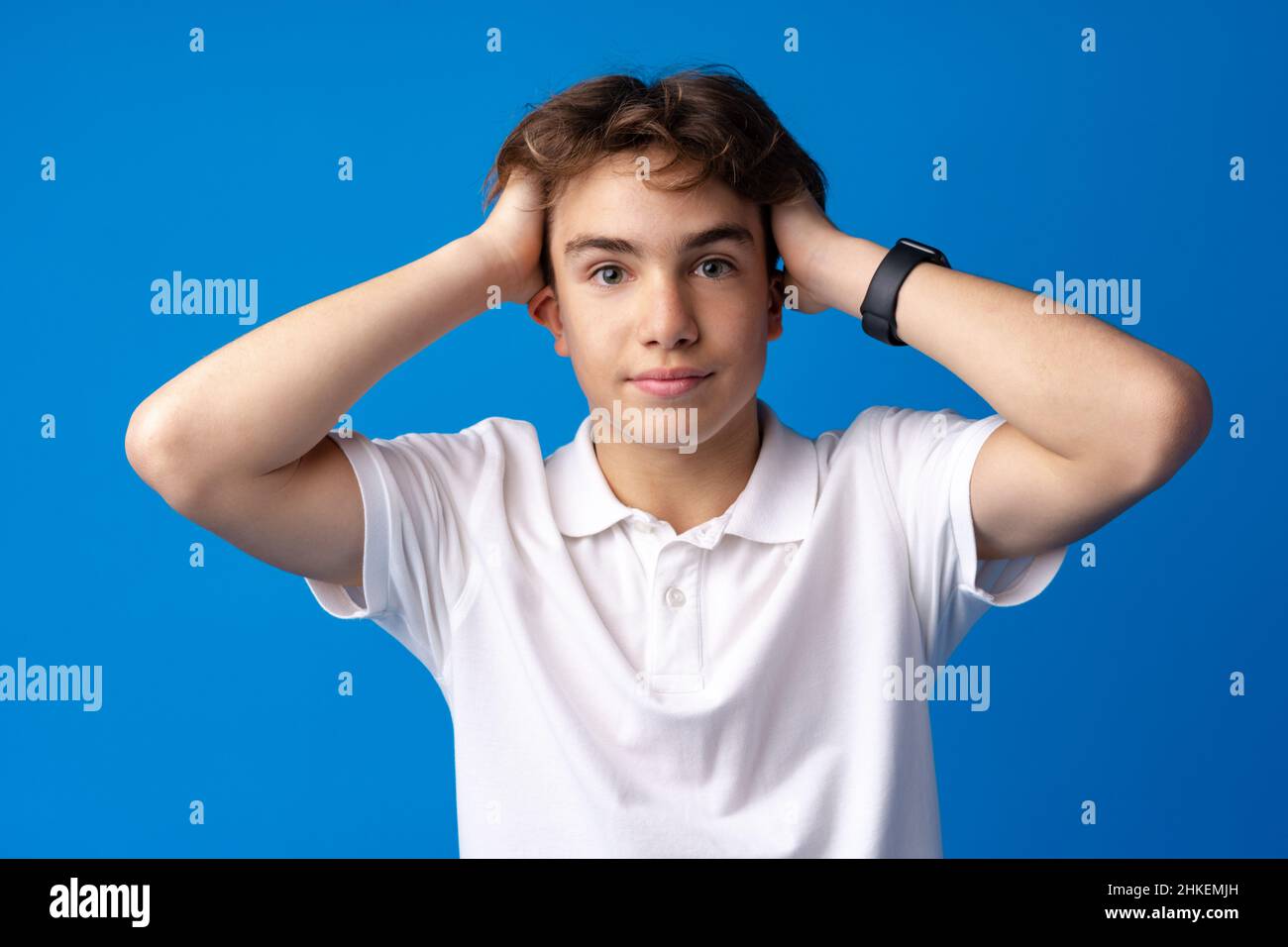 Sad teenager boy failed, touching face against blue background Stock ...