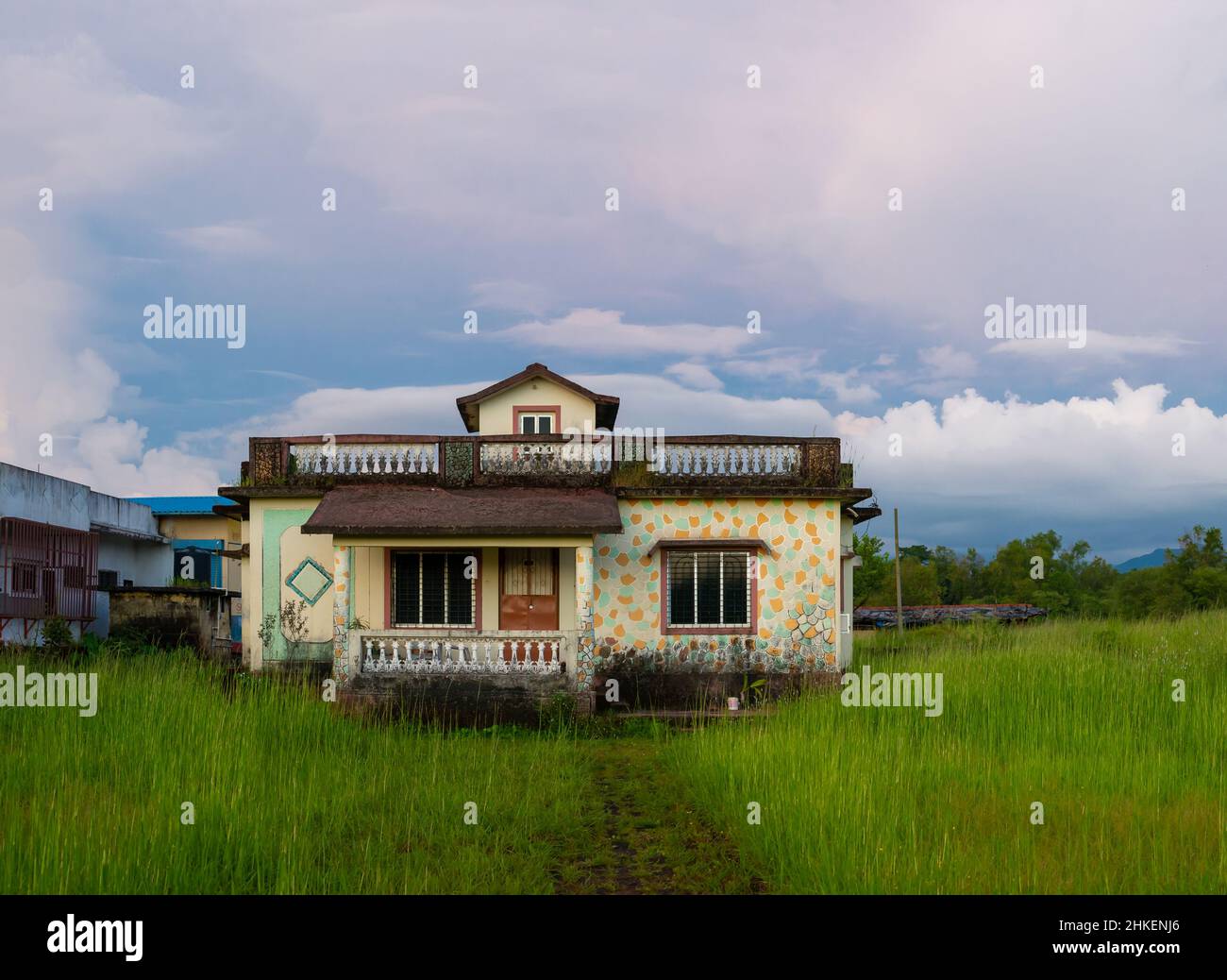 Traditional Indian village house surrounded by green grass and beatiful ...