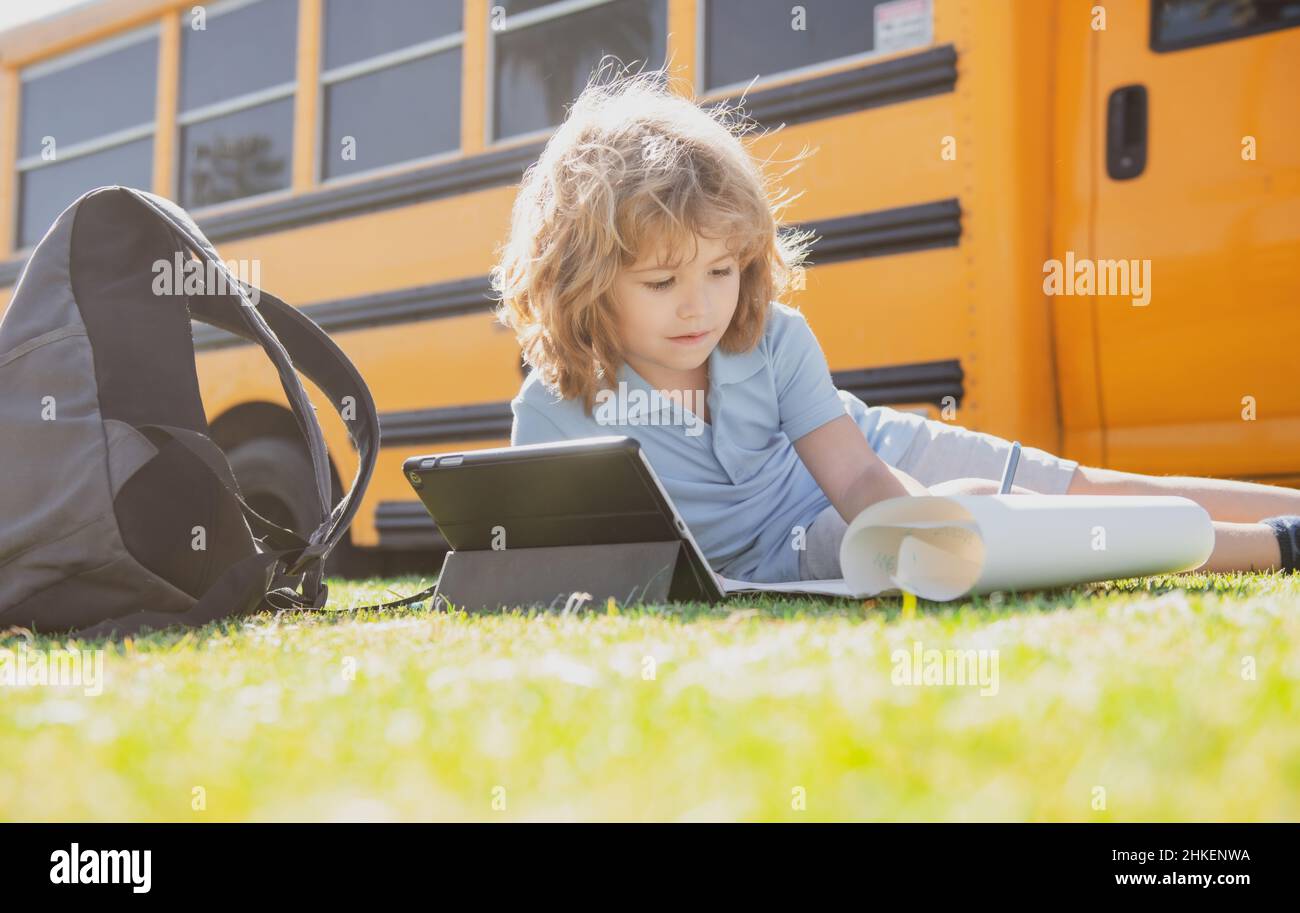 Back to school. Happy child study in park near school bus. Schoolboy ...