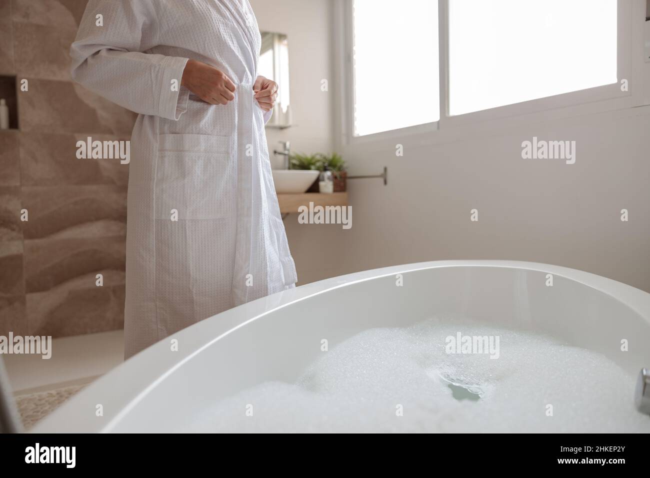 Adult woman getting ready to take bath Stock Photo - Alamy