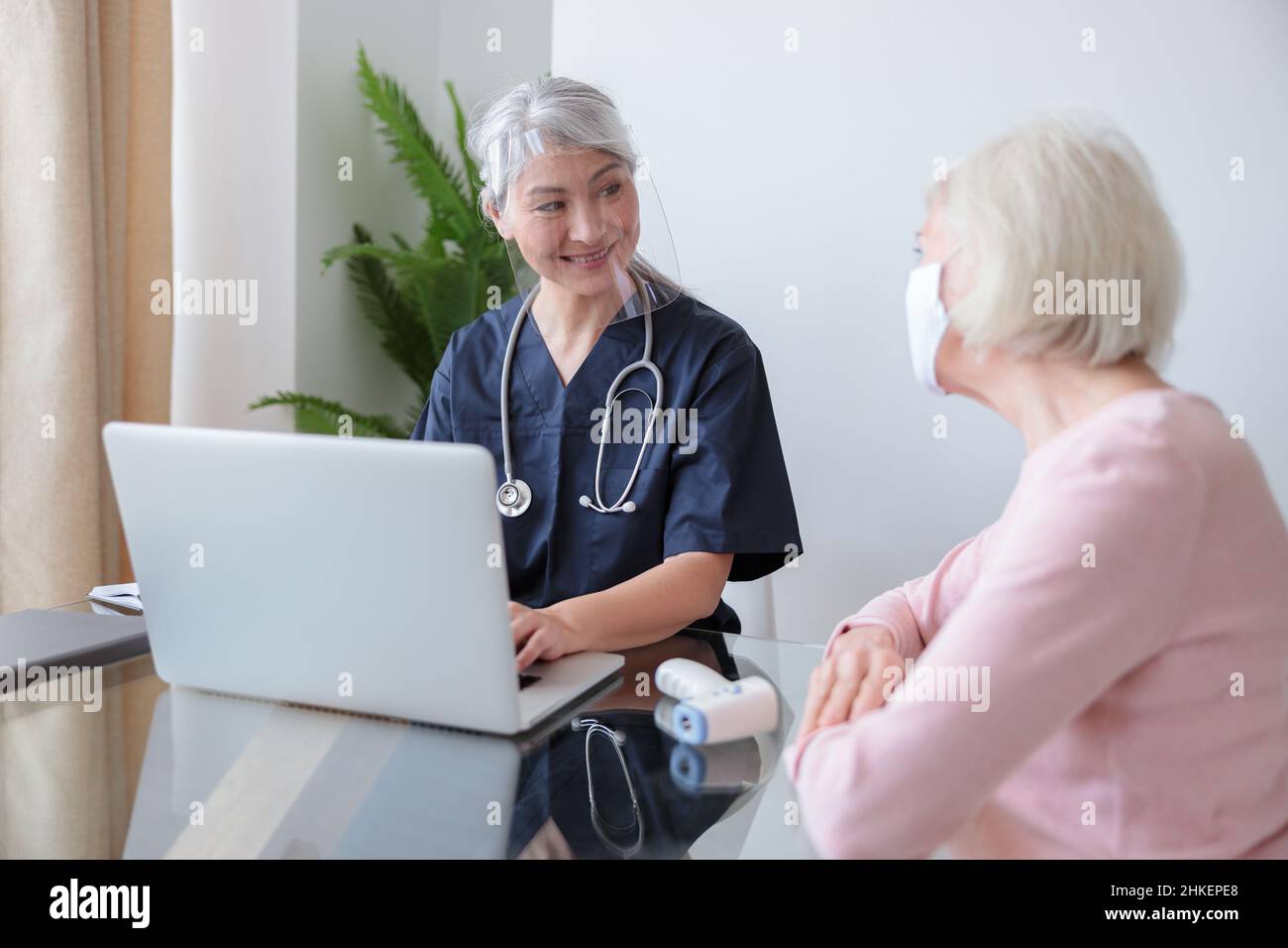 Retired patient with her doctor on appointment Stock Photo - Alamy