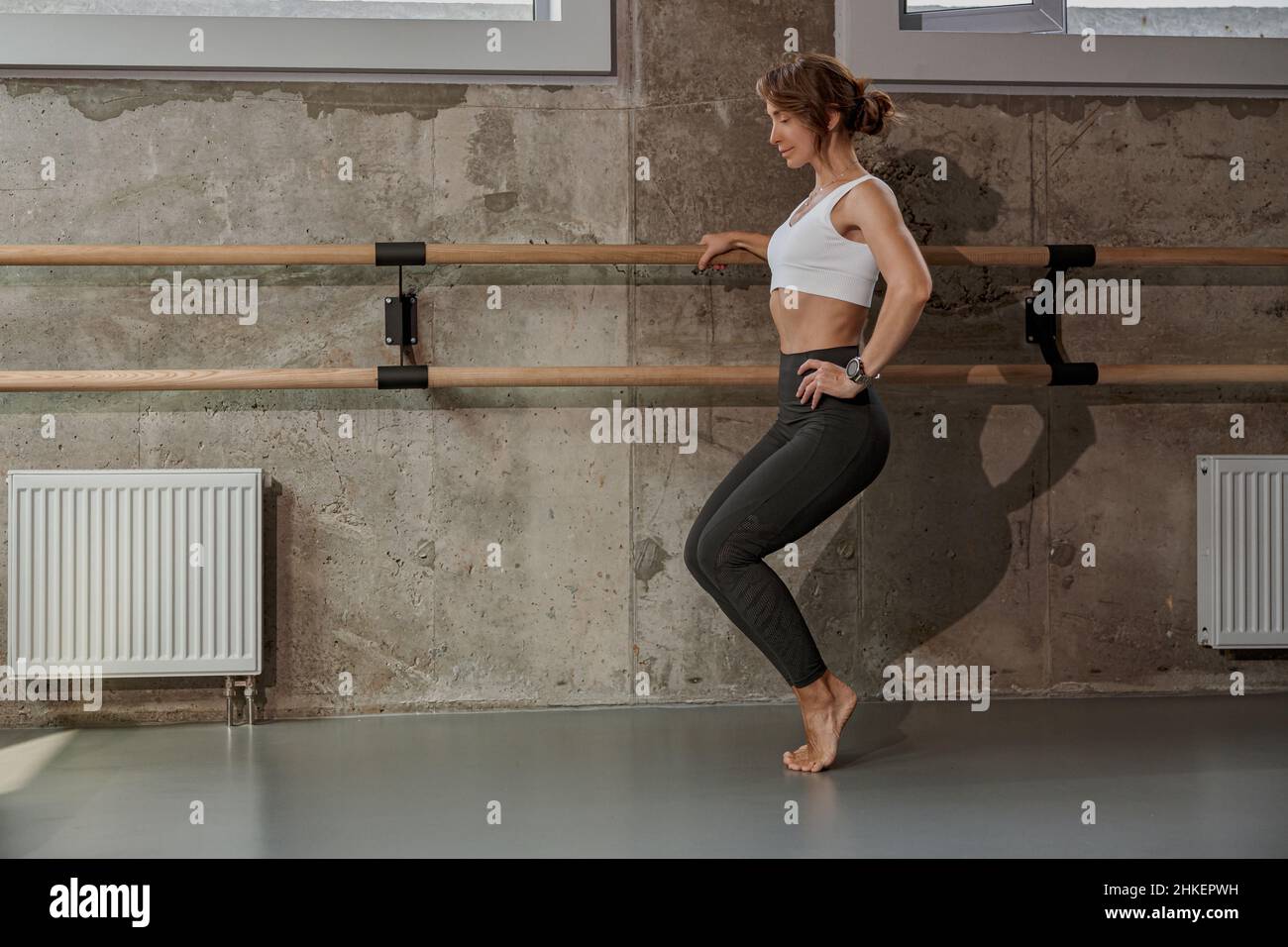 Attractive female athlete working out at fitness center Stock Photo - Alamy