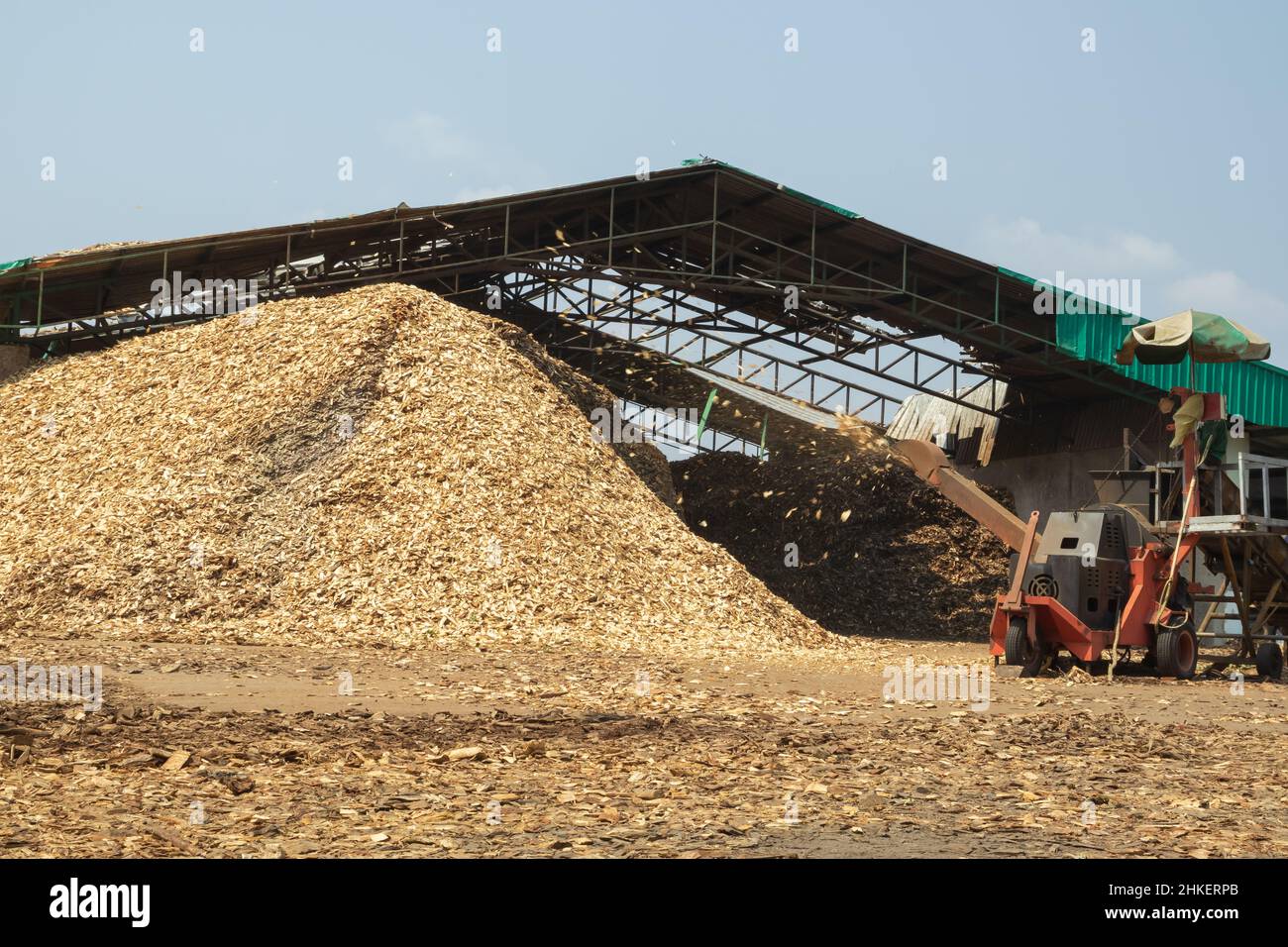 The wood chopping machine is working. To make large pieces of wood into ...