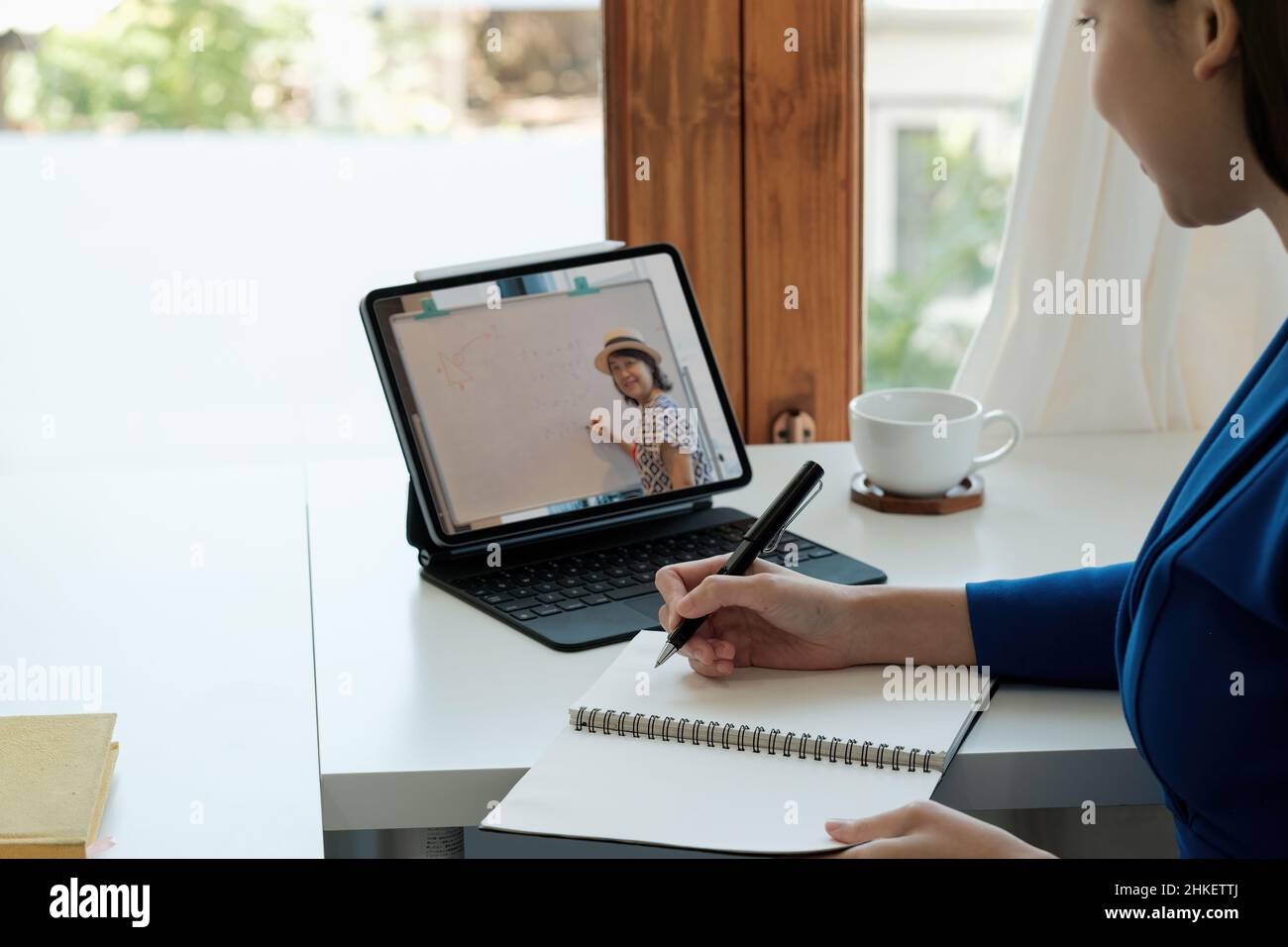 Young student watching lesson online and studying from home. Young ...