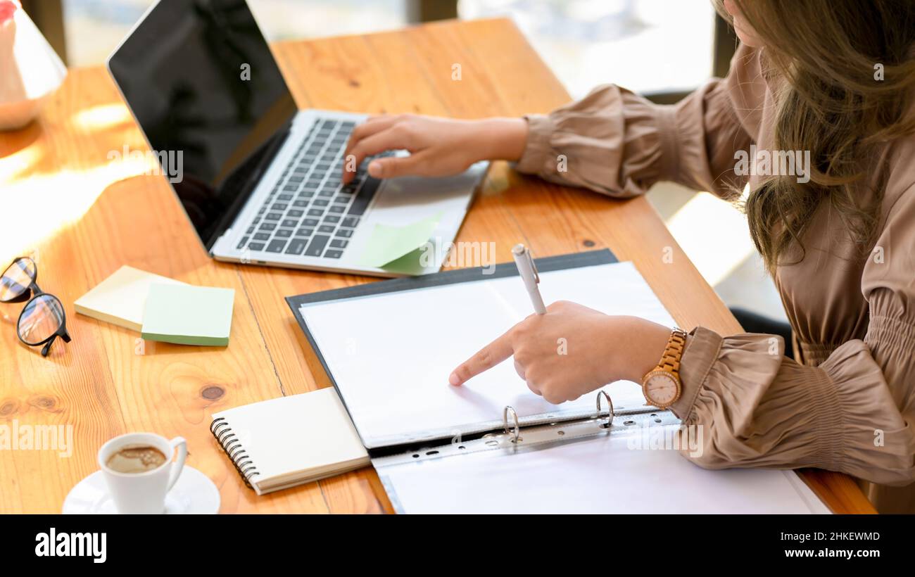 Cropped image, A businesswoman or female accountant working on laptop ...