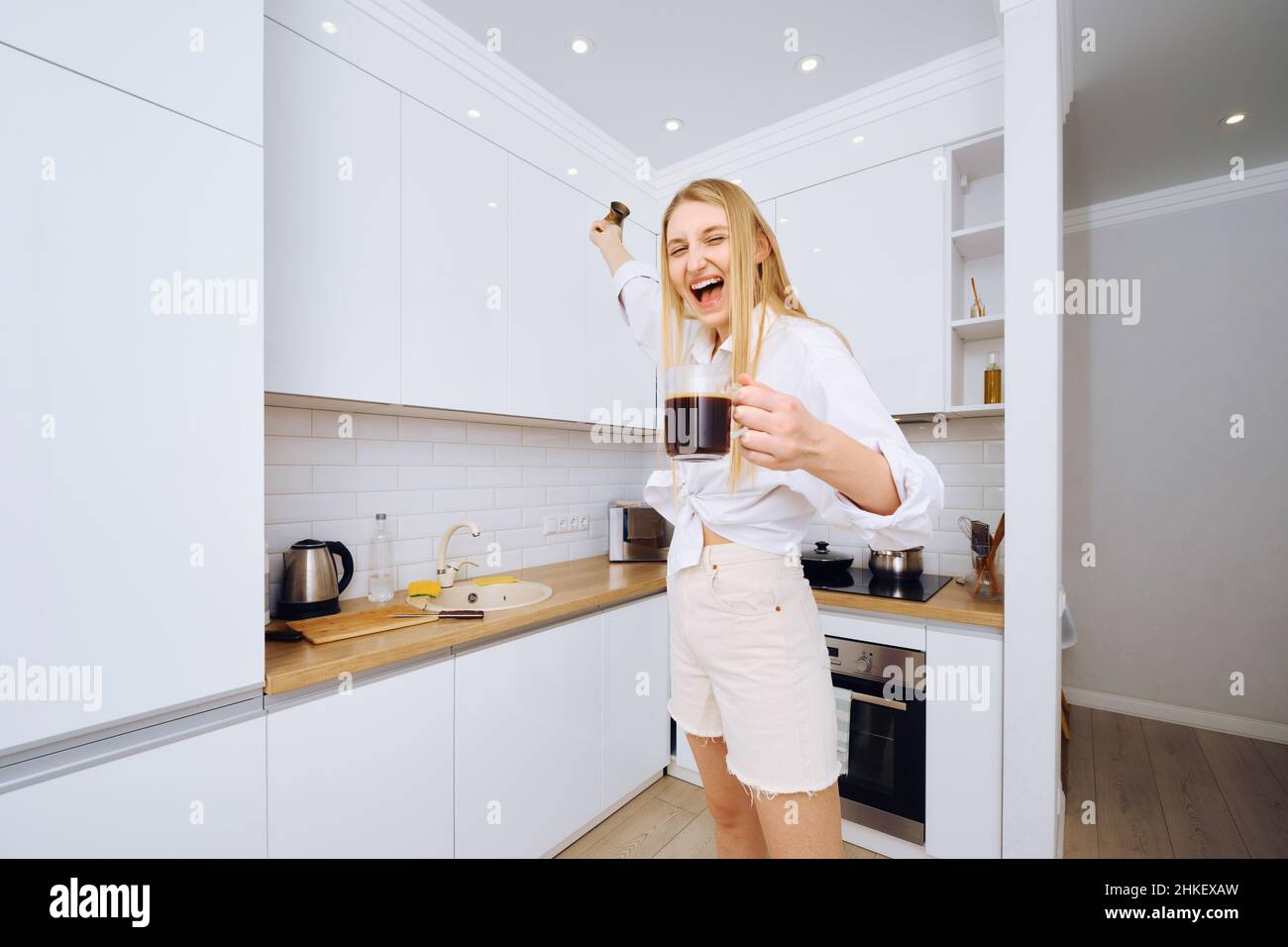 Woman dancing in kitchen hi-res stock photography and images - Alamy