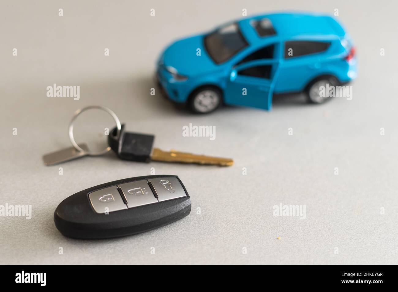Toy car and keys car on white background Stock Photo - Alamy