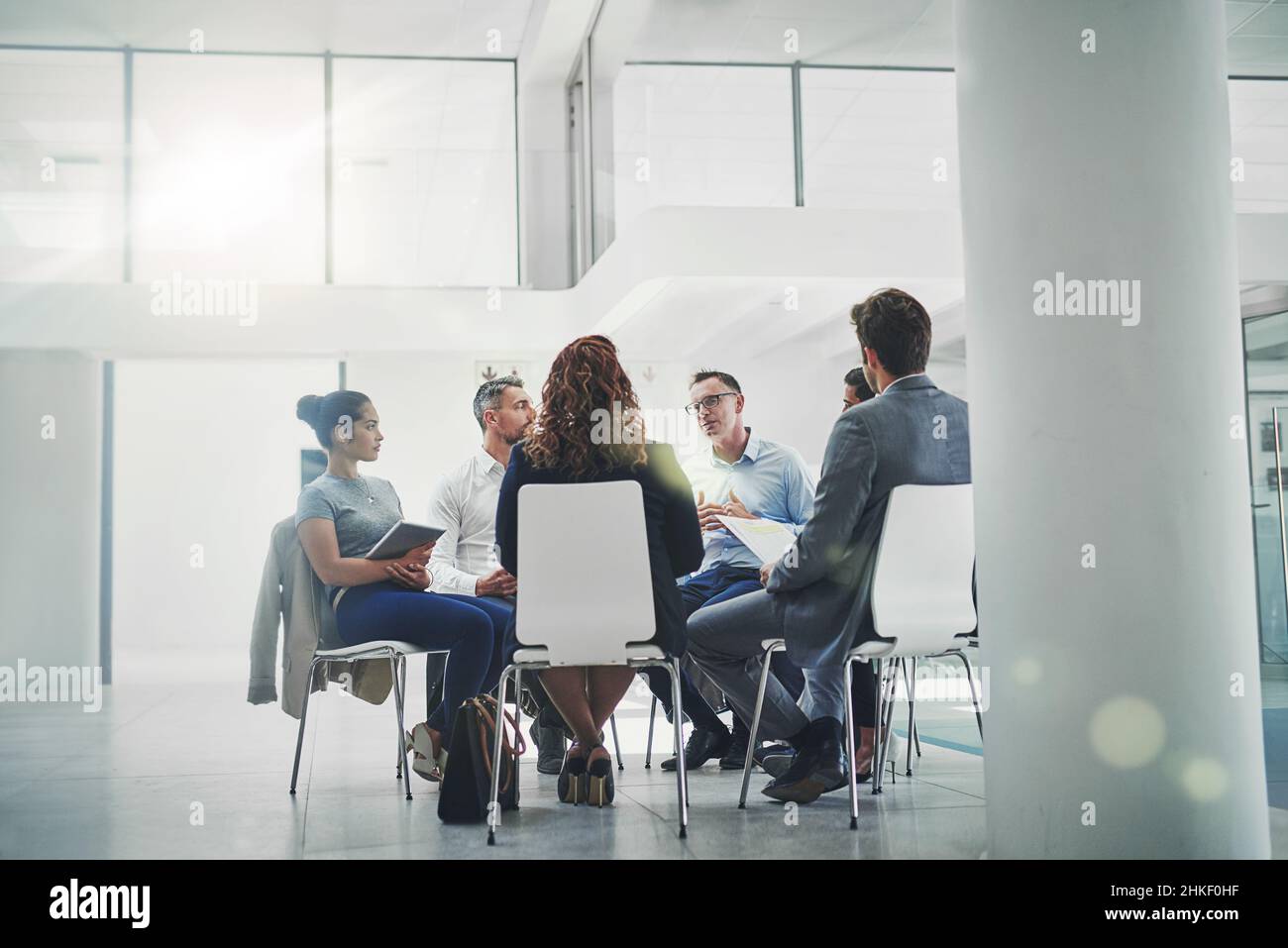 Exchanging ideas. Shot of a group of coworkers talking together while ...