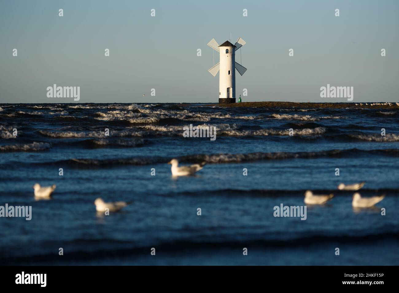 Seascape with lighthouse looks like windmill. Swinoujcie in Poland ...